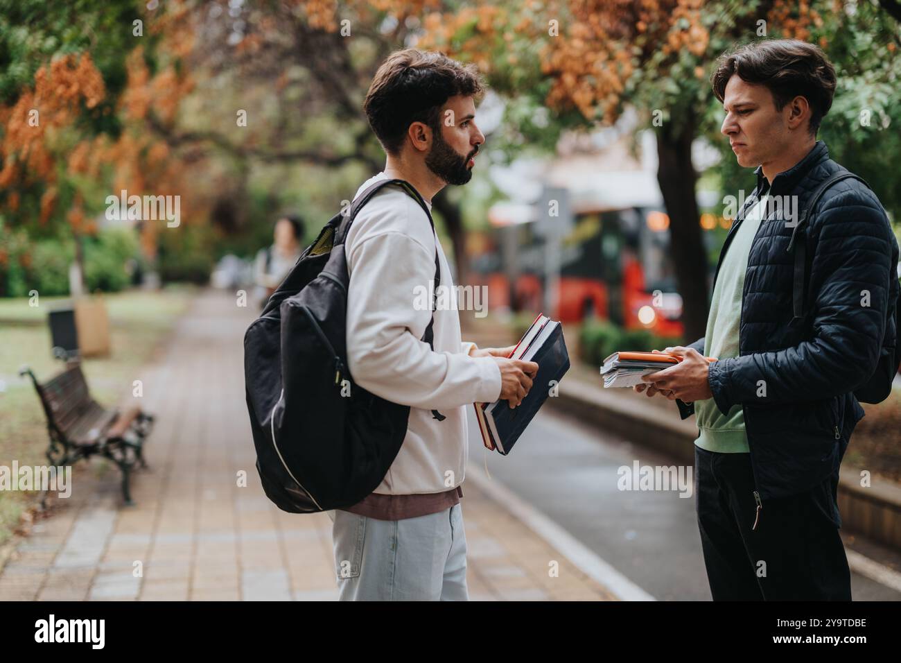 Group of college students discussing after exam outdoors on campus ...