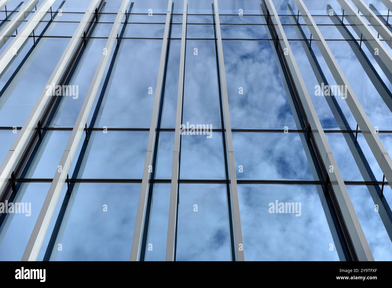 Skyscraper glass window facade, clouds reflecting on windows Stock Photo - Alamy