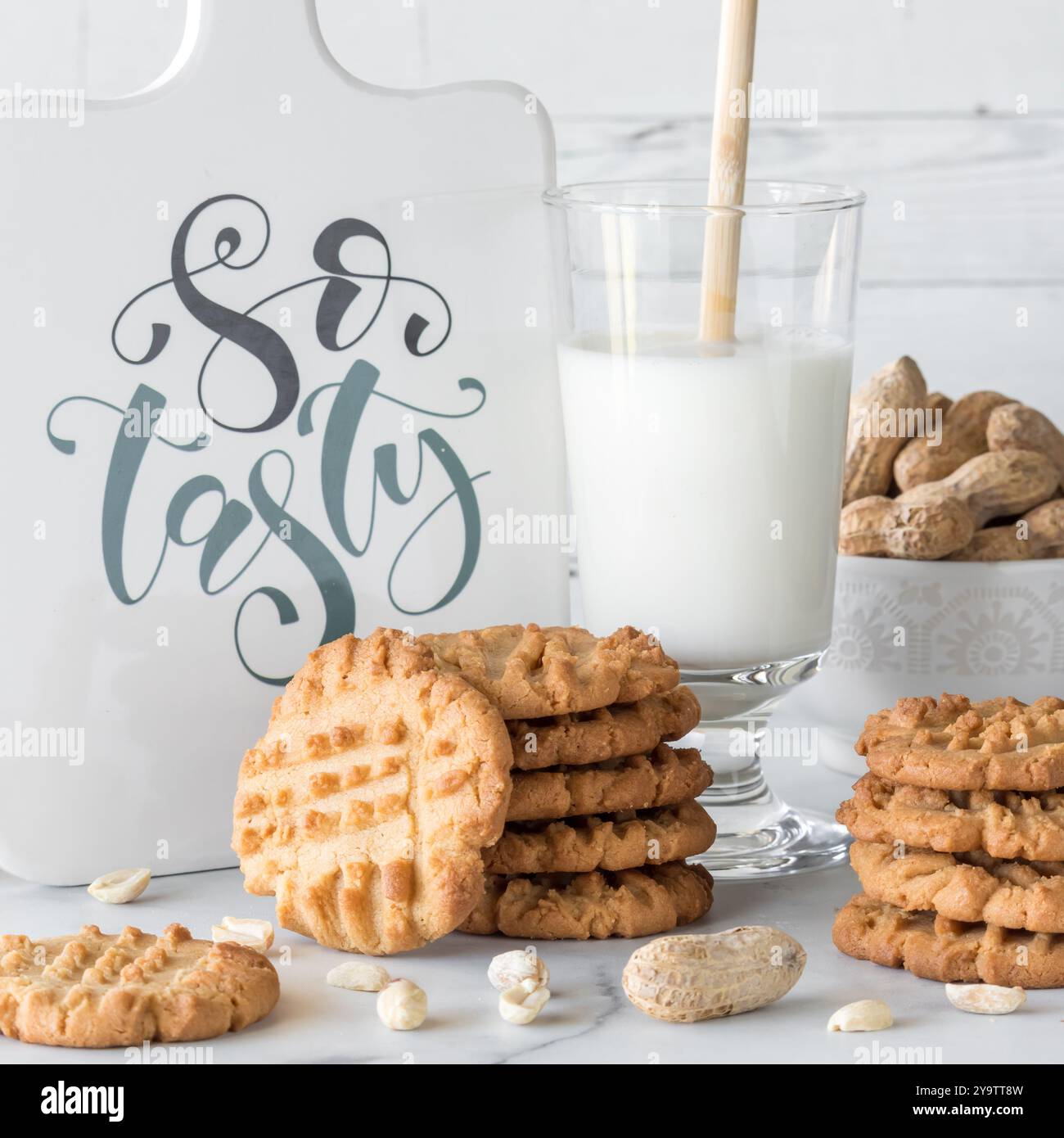 Stacks of peanut butter cookies served with milk and peanuts Stock ...