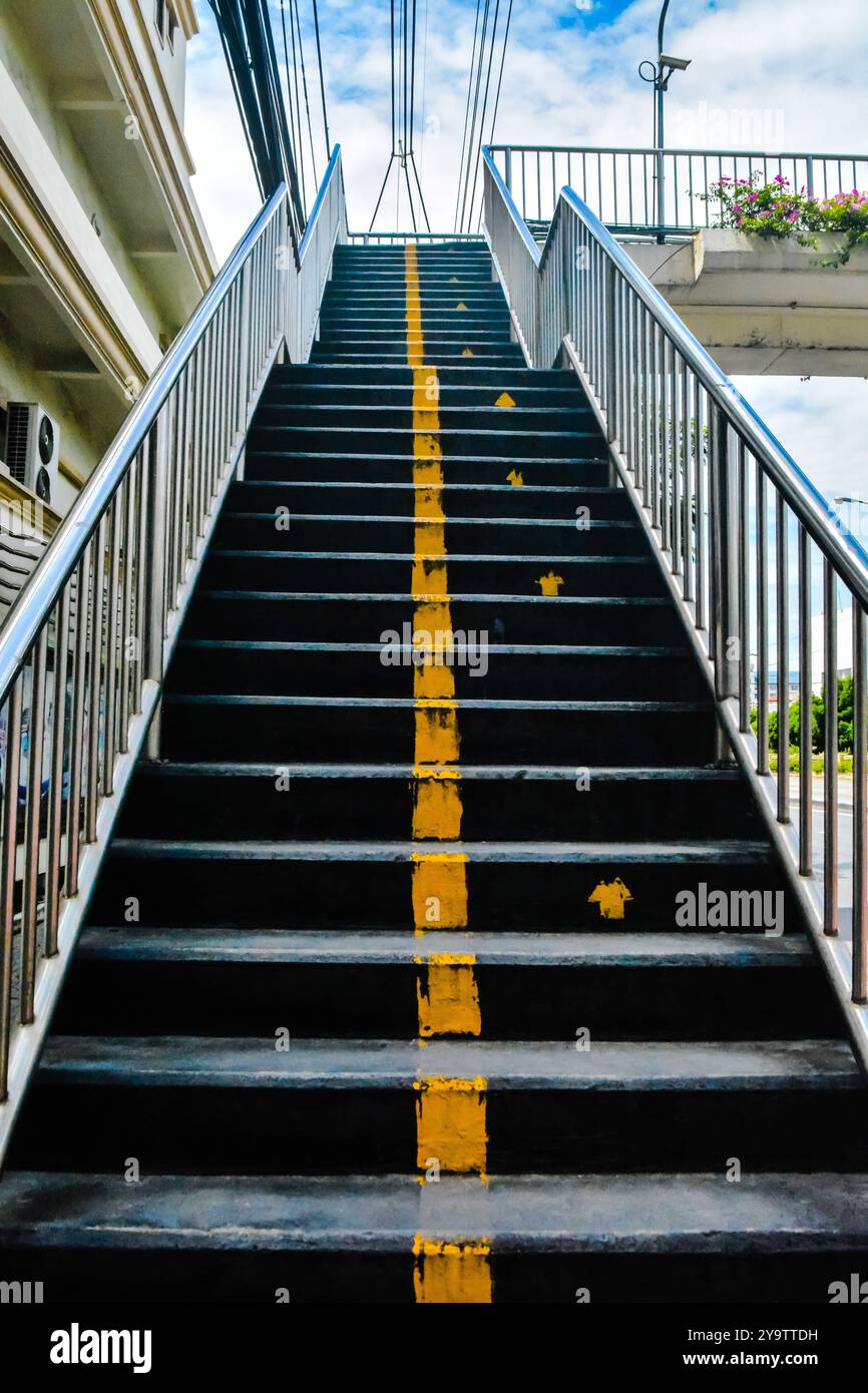 Stairs overpasses for people to cross the road safely.Yellow lines ...