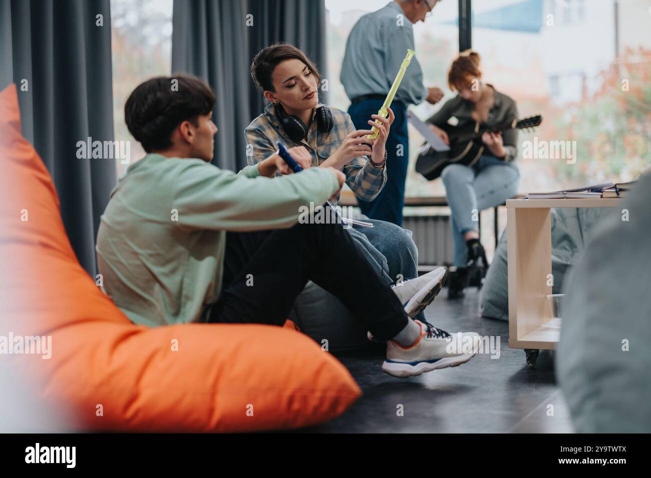 College students engaged in interactive music class session Stock Photo ...