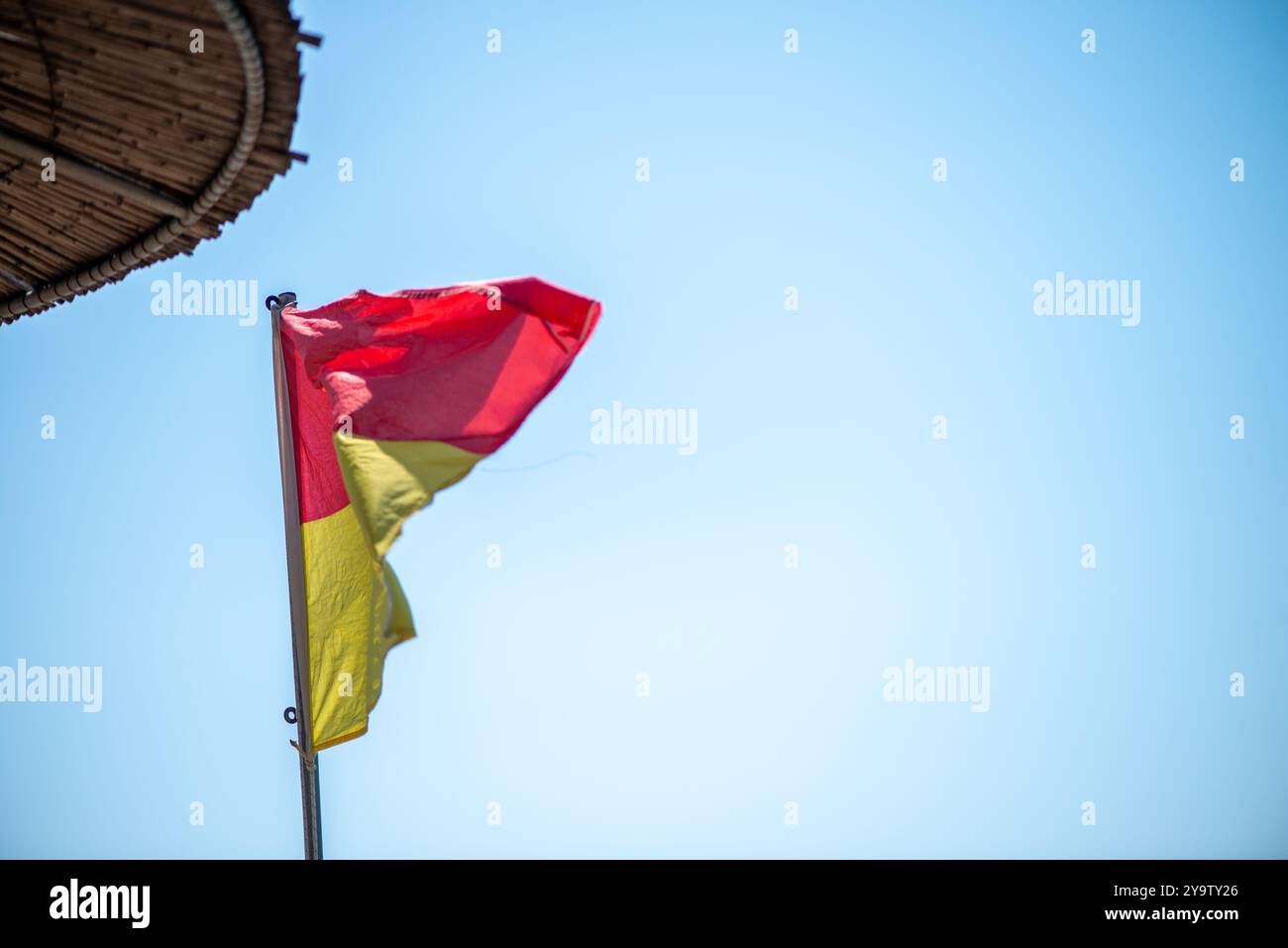A dynamic image of a lifeguard flag waving in the wind, symbolizing ...