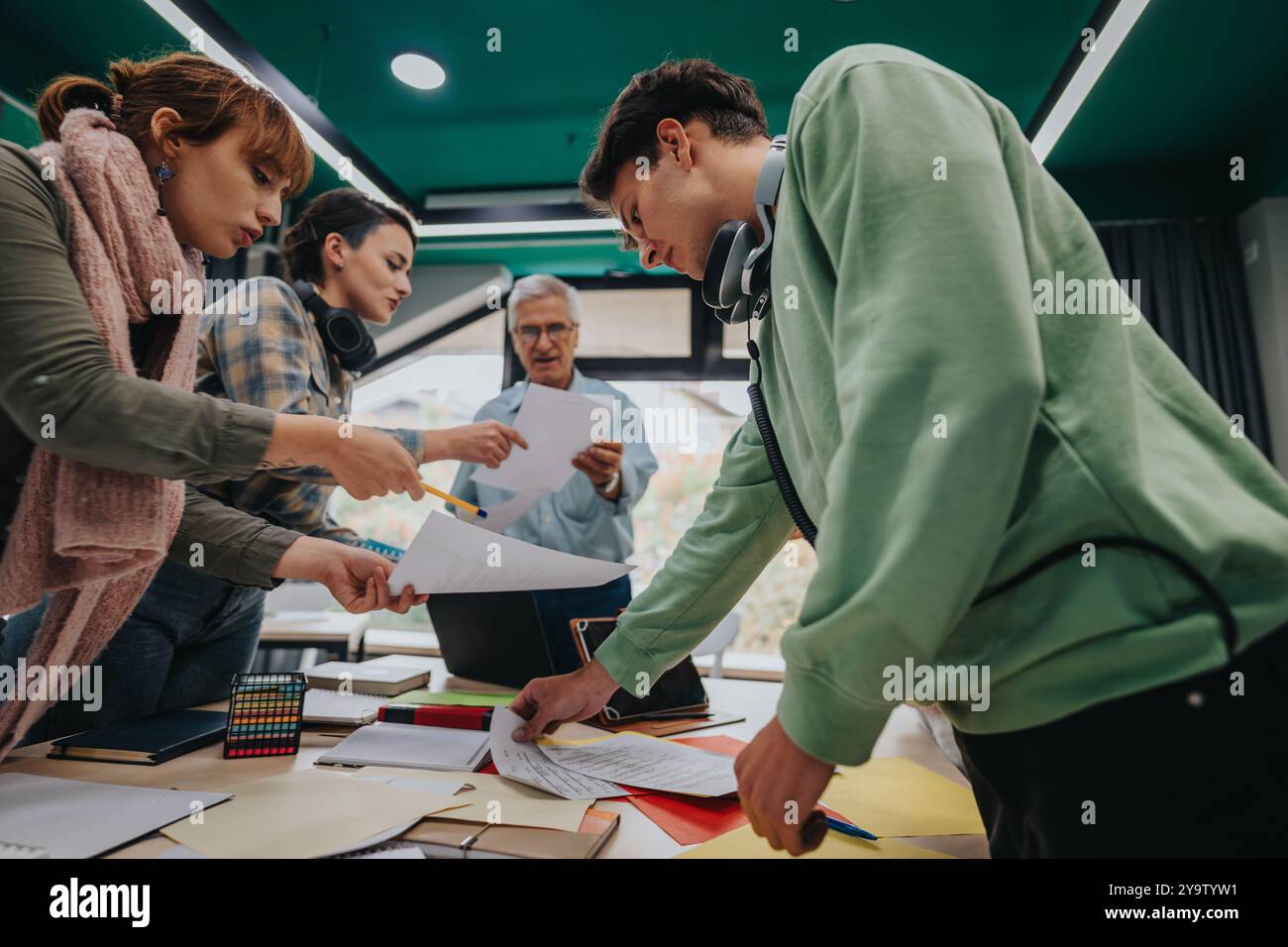 College students collaborating with professor in modern classroom environment Stock Photo - Alamy