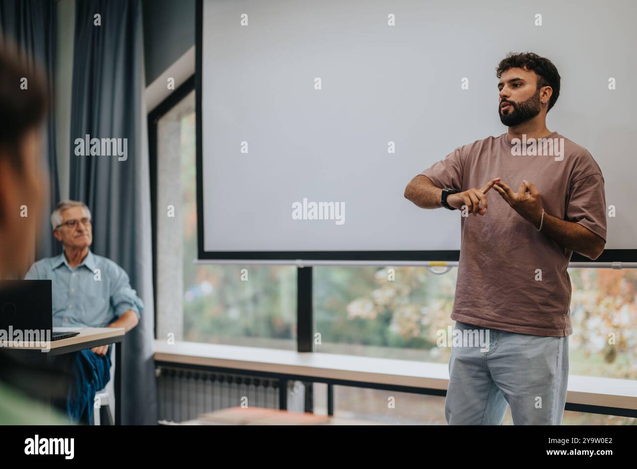 Man giving presentation with audience in modern office setting Stock ...