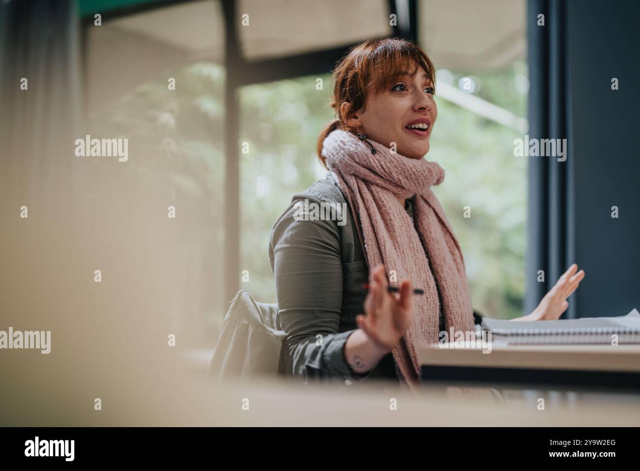 Student speaking in a cozy classroom environment with natural light ...
