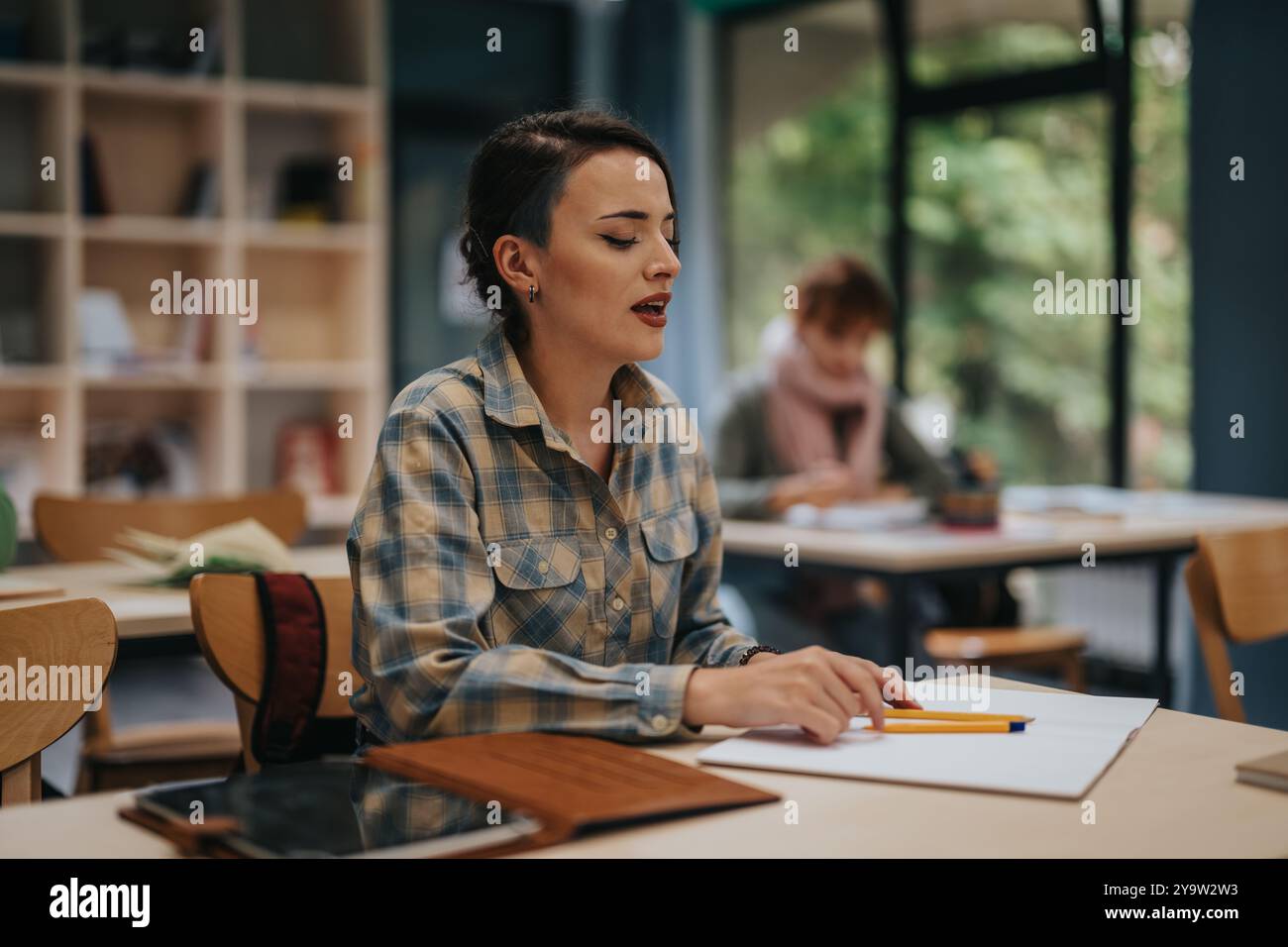 Students engaged in learning at a cozy classroom environment Stock ...