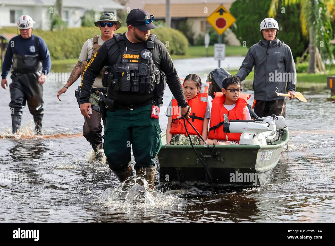 Ruby Bishop and her son Alex are evacuated from her home by Pasco County Fire and Rescue and ...