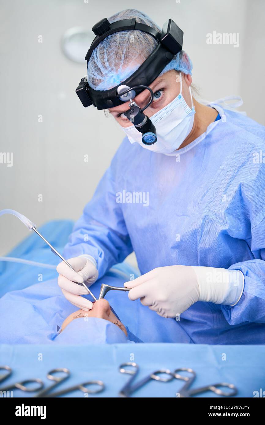 Professional surgeon performing surgery in modern operating room Stock ...