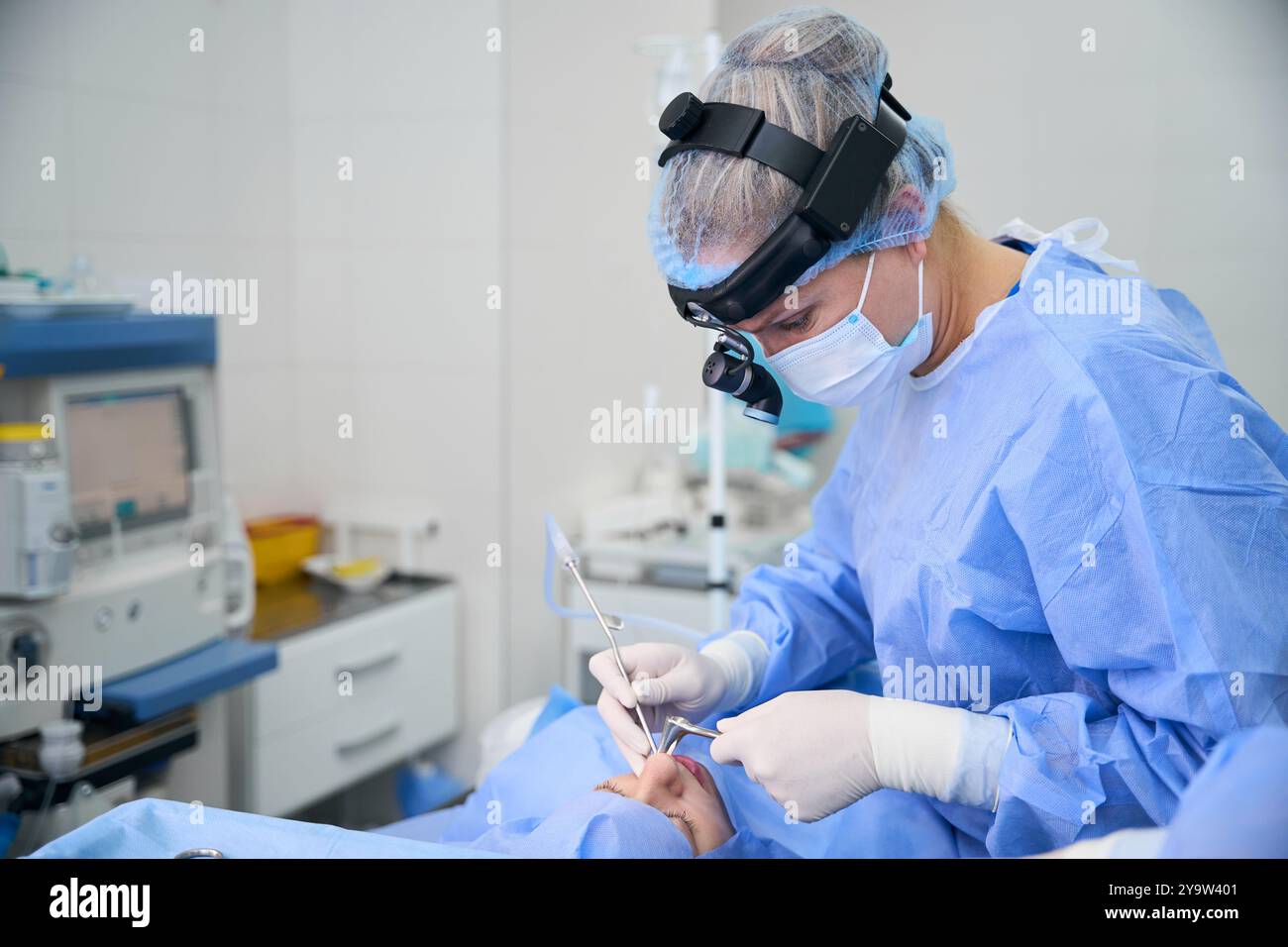 Professional otolaryngologist surgeon performing surgery in modern ...