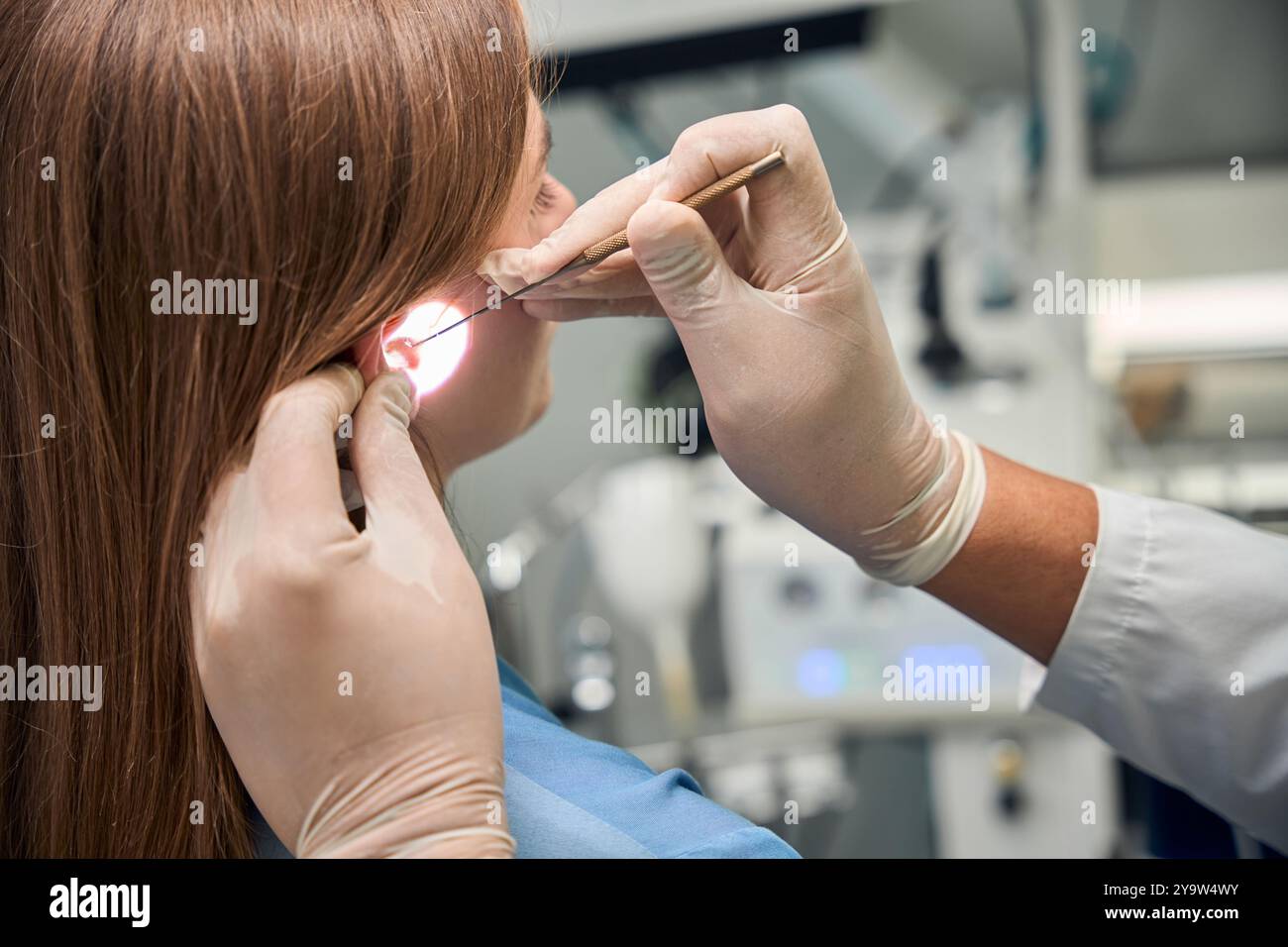 Female otolaryngologist examining ear hi-res stock photography and ...