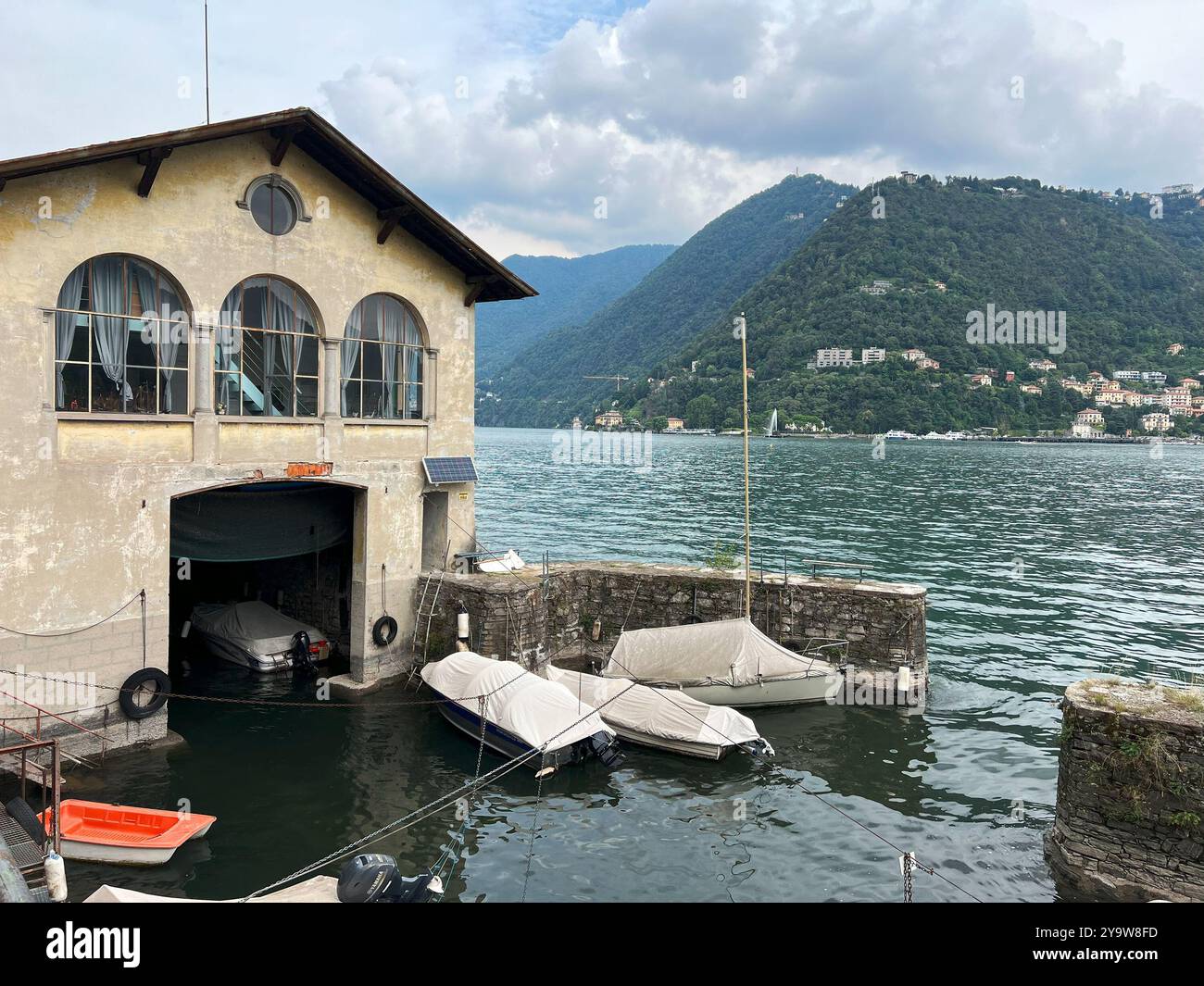 House with boat parking arrangement in basement on lake Como Stock ...