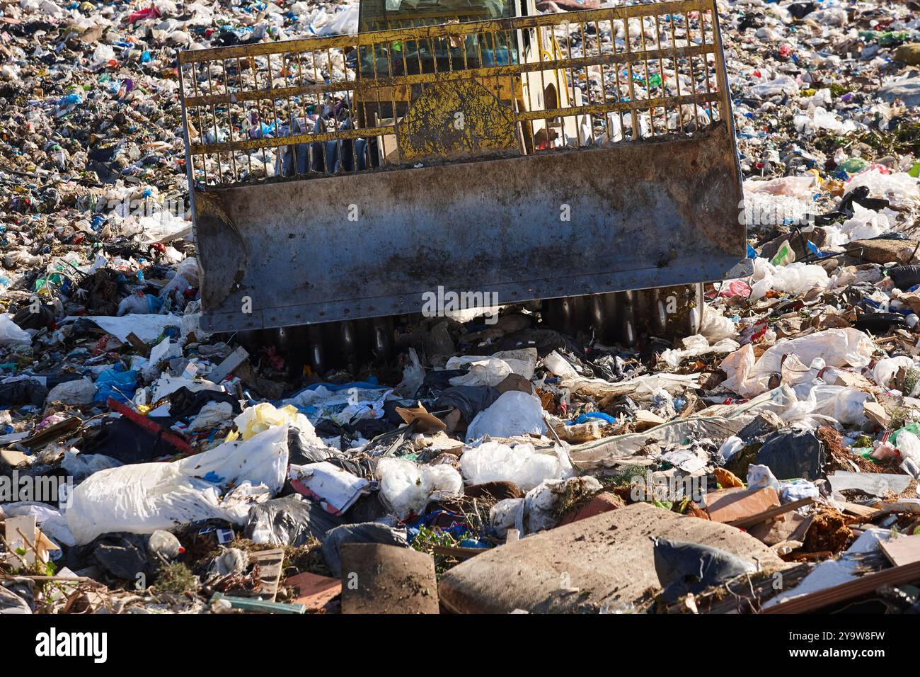 Heavy machinery shredding garbage in an open air landfill. Waste Stock ...