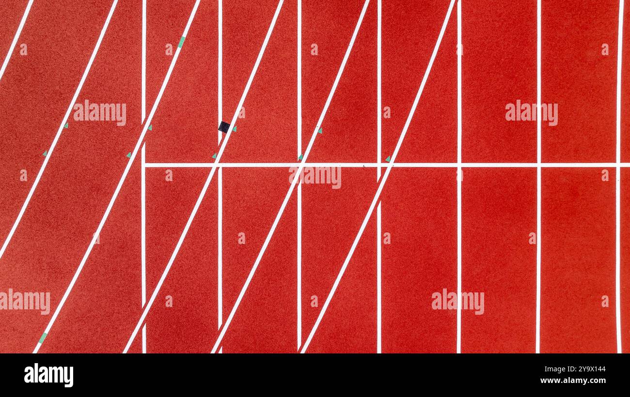Aerial image of a new red running track with white lane lines and other ...