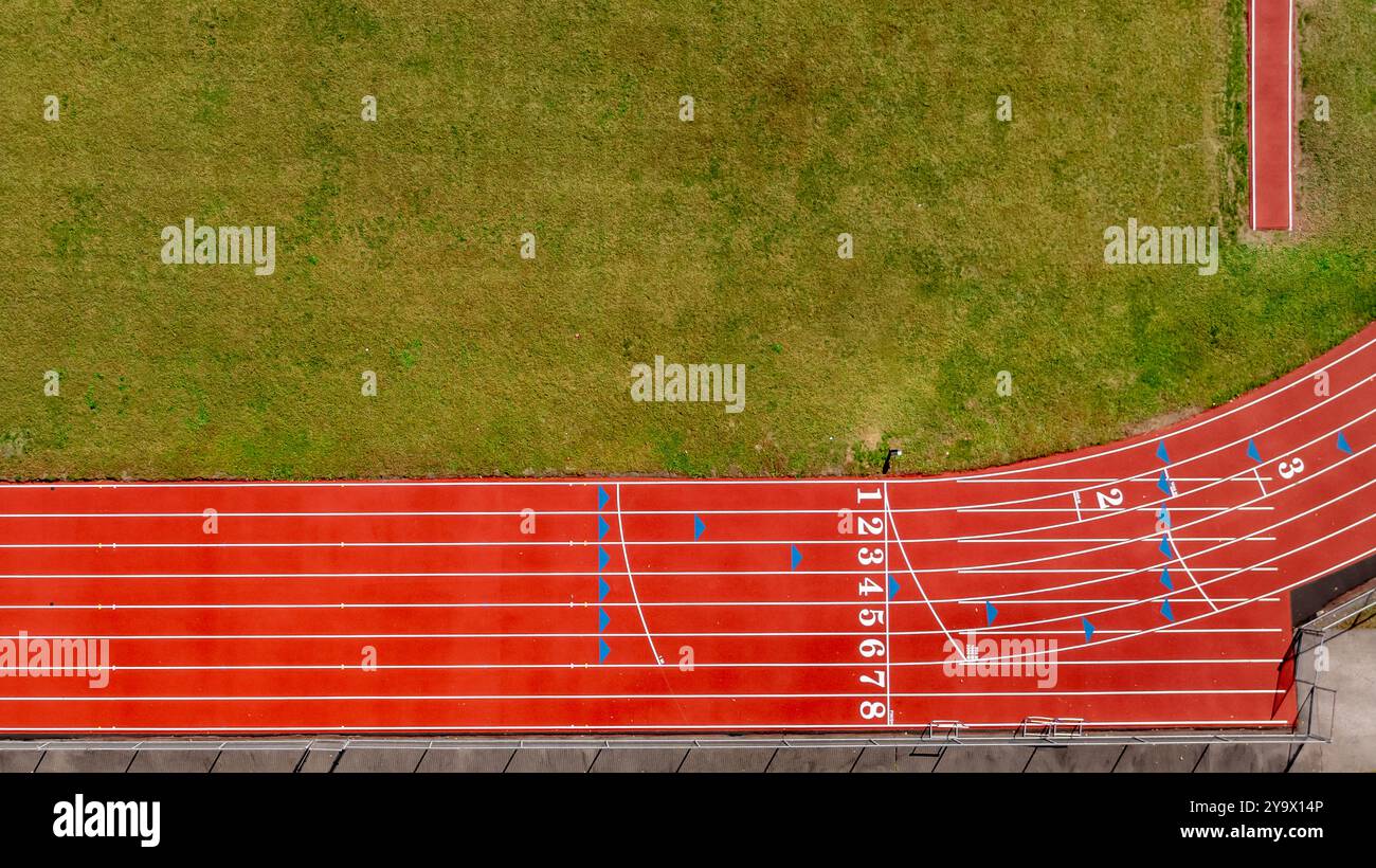 Aerial image of a new red running track with white lane lines and other ...