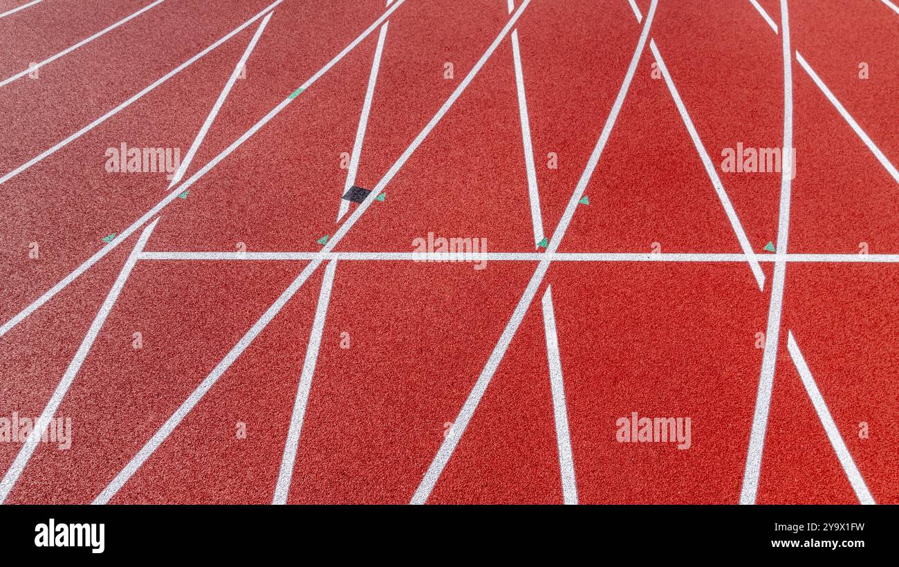 Aerial image of a new red running track with white lane lines and other ...