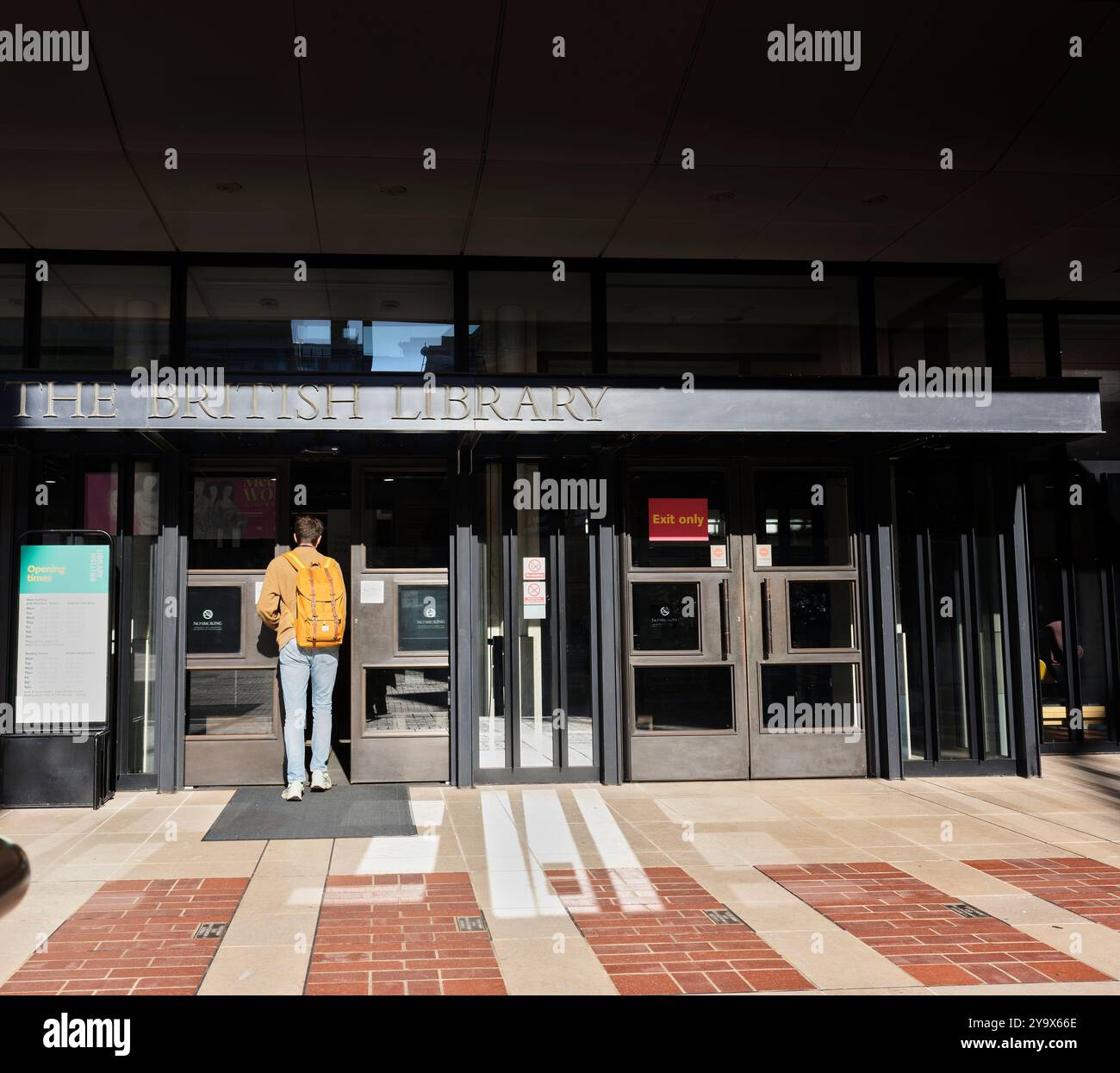A male student at the main entrance to the British Library, London ...