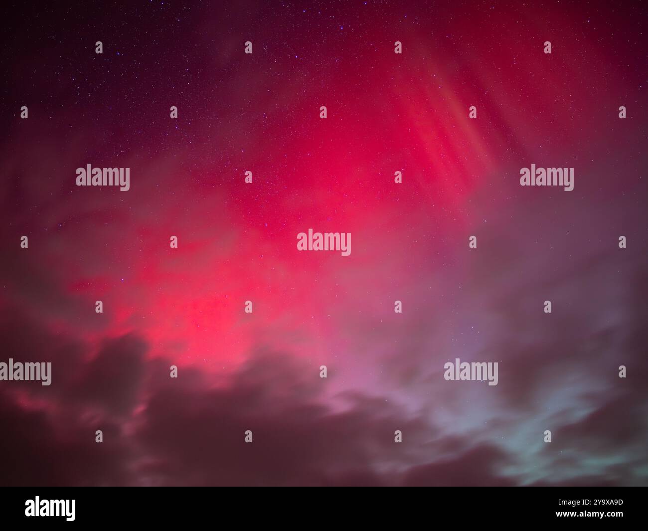 Red polar lights high up in the sky. Rays of the aurora borealis above ...