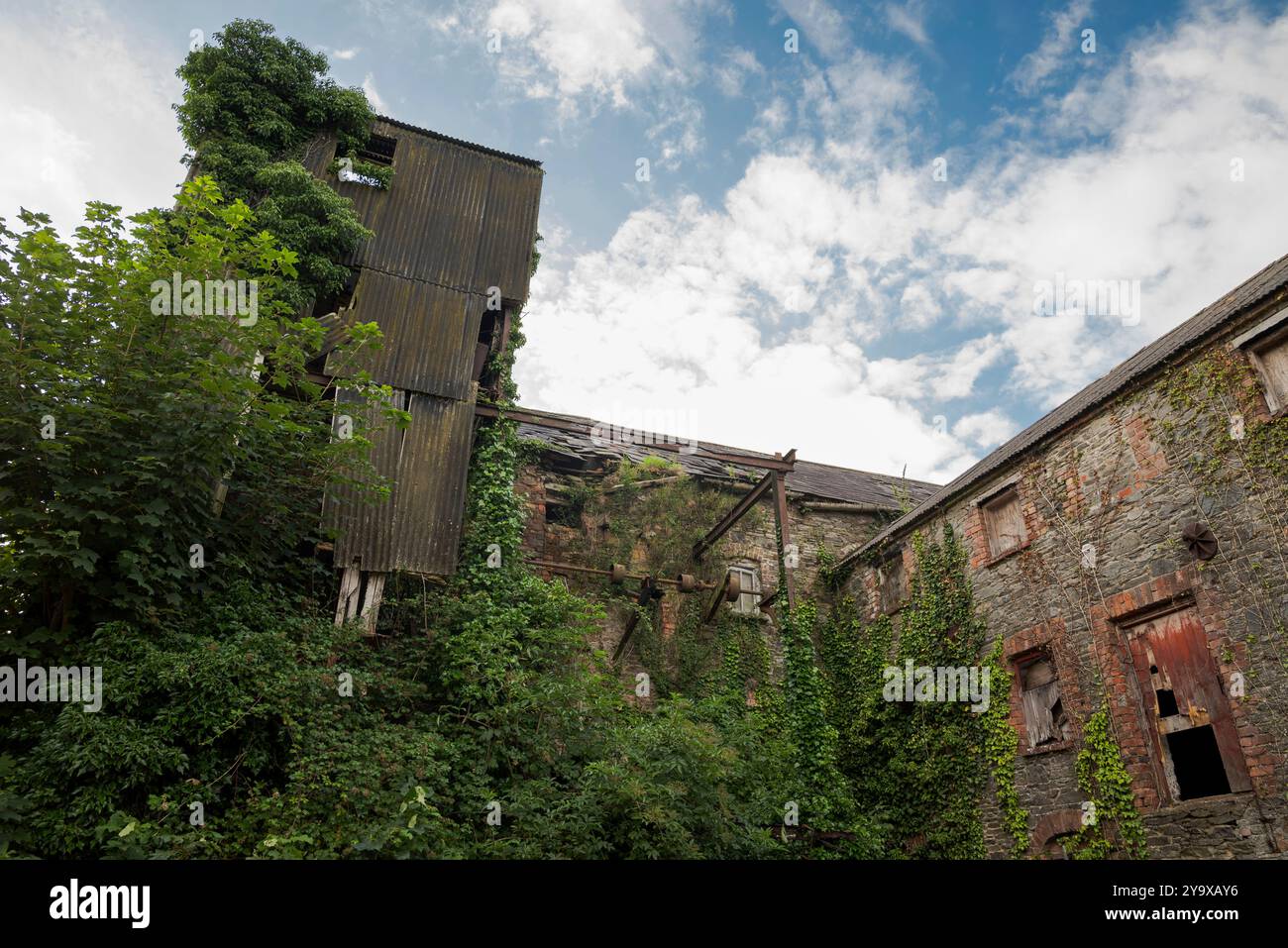 Ruins of an abandoned, industrial building shows crumbling stone and ...