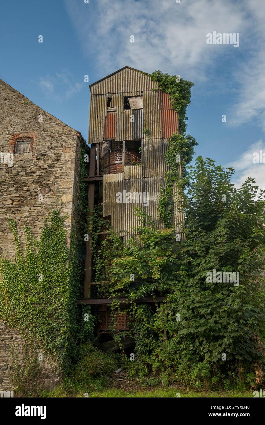 Ruined tower covered with corrugated asbestos roofing sheets and ...