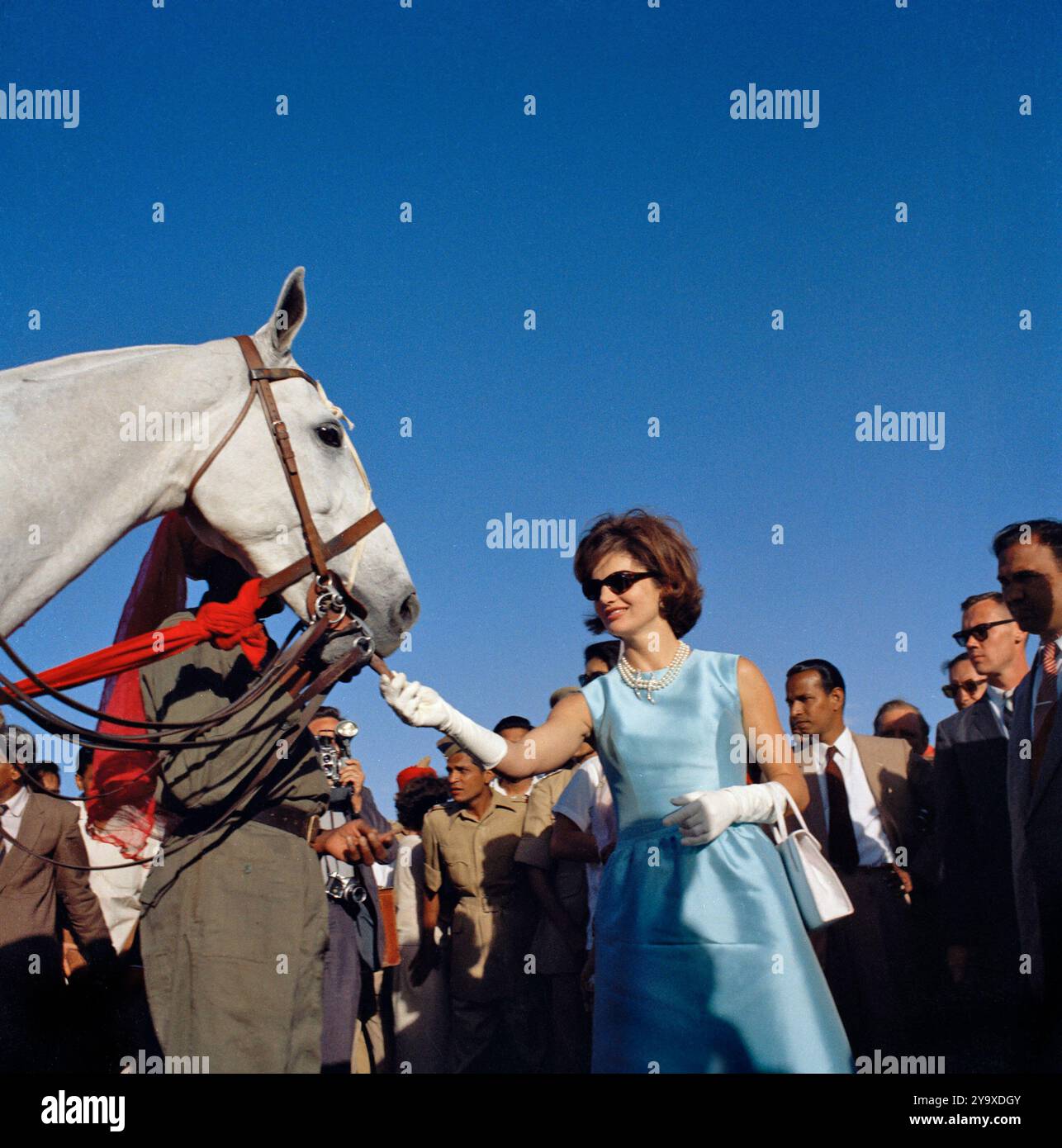 U.S. First Lady Jacqueline Kennedy feeding horse while attending polo ...