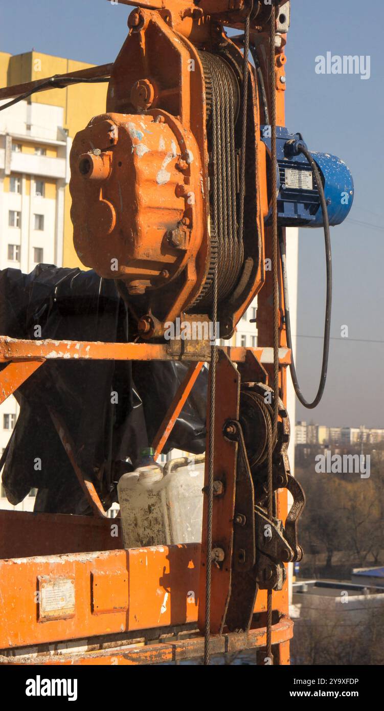 The Orange Crane cradle platform Stock Photo - Alamy