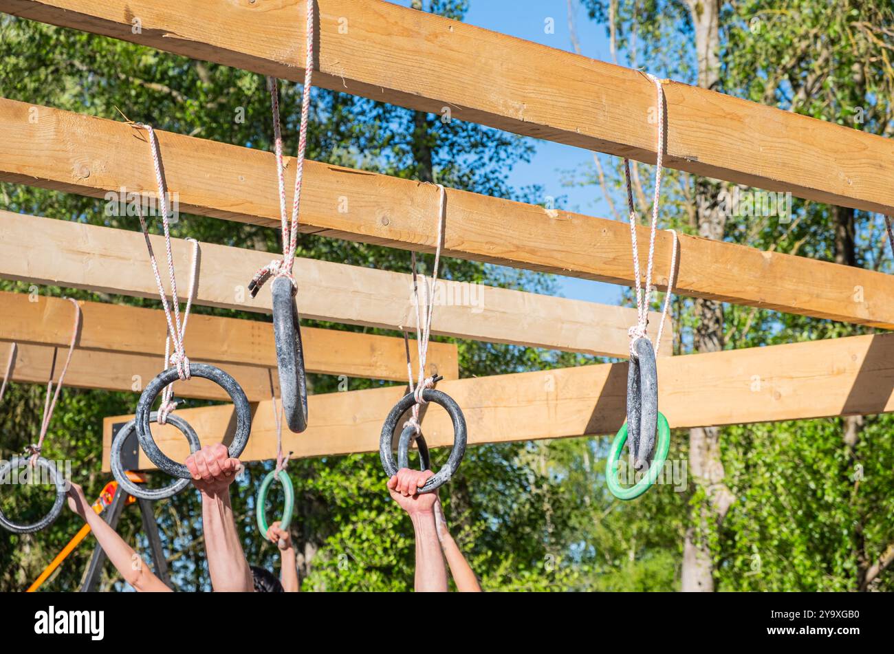 athletes overcoming one of the trials in an OCR race, a sports ...