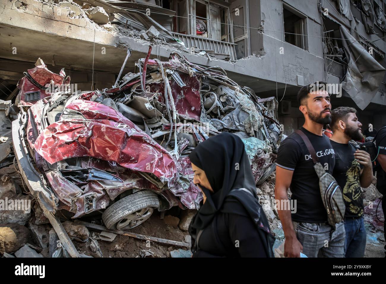 Locals look at the damages caused by an an Israeli air strike on Mamoun ...