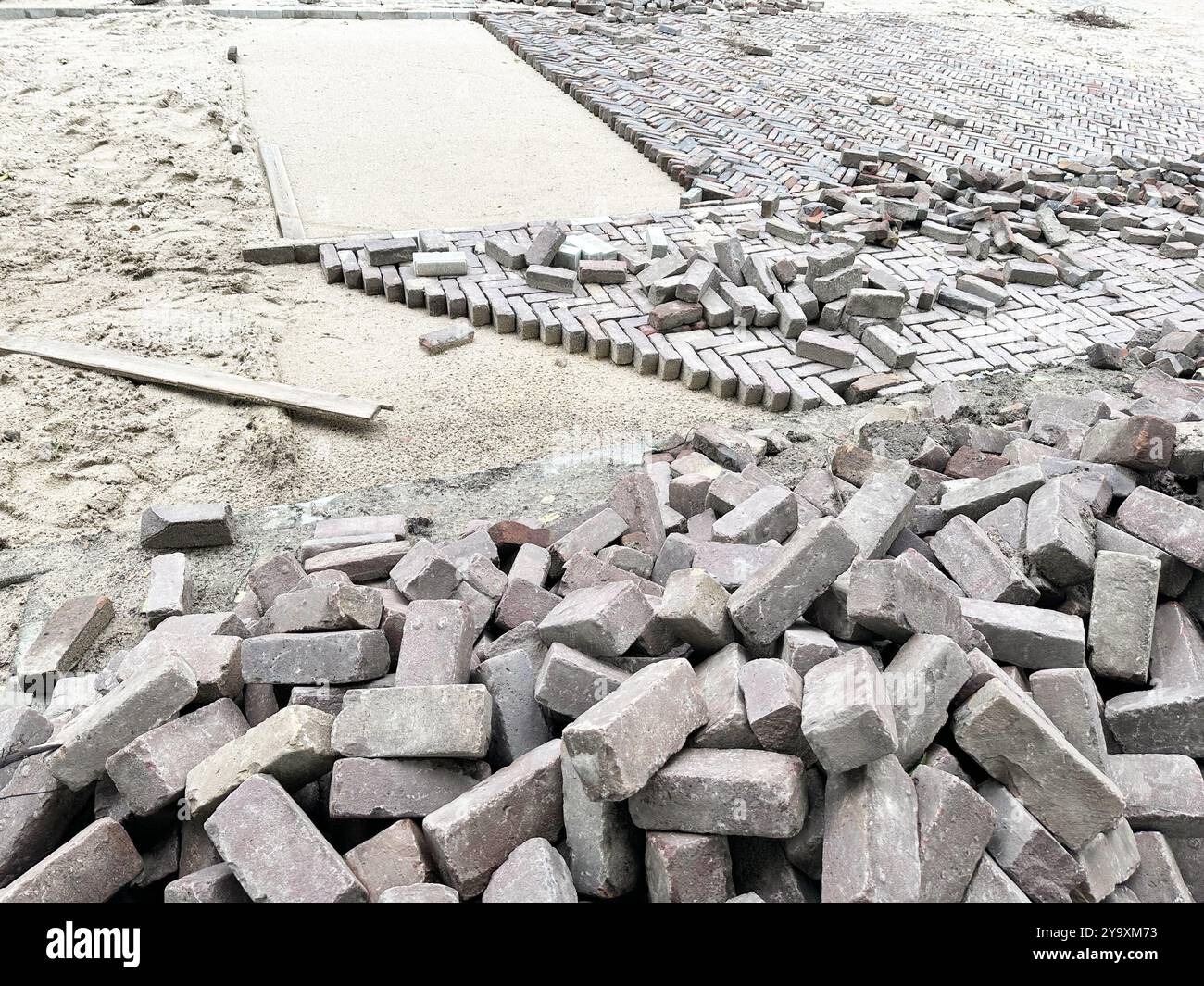Process of laying paving stone blocks outdoors Stock Photo - Alamy