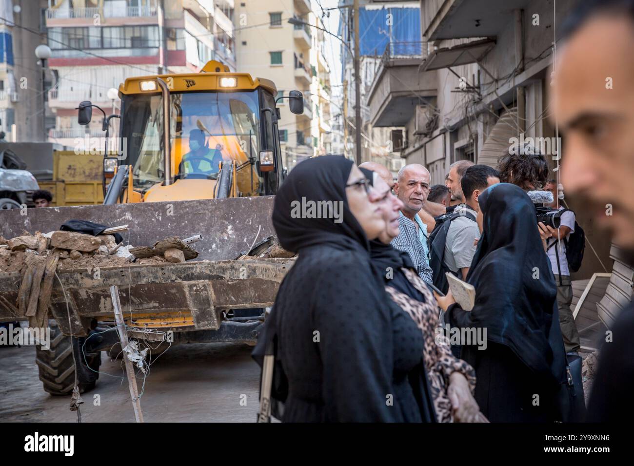 Locals look at the damages caused by an an Israeli air strike on Mamoun ...