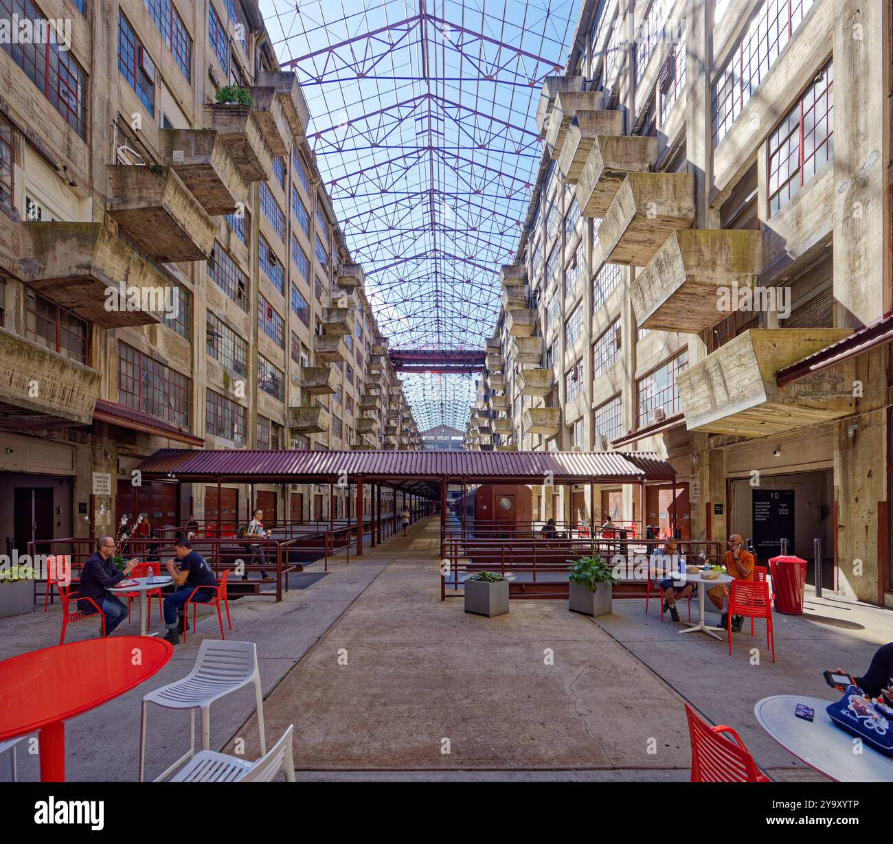 Tenants take a break in the cavernous atrium of Brooklyn Army Terminal ...