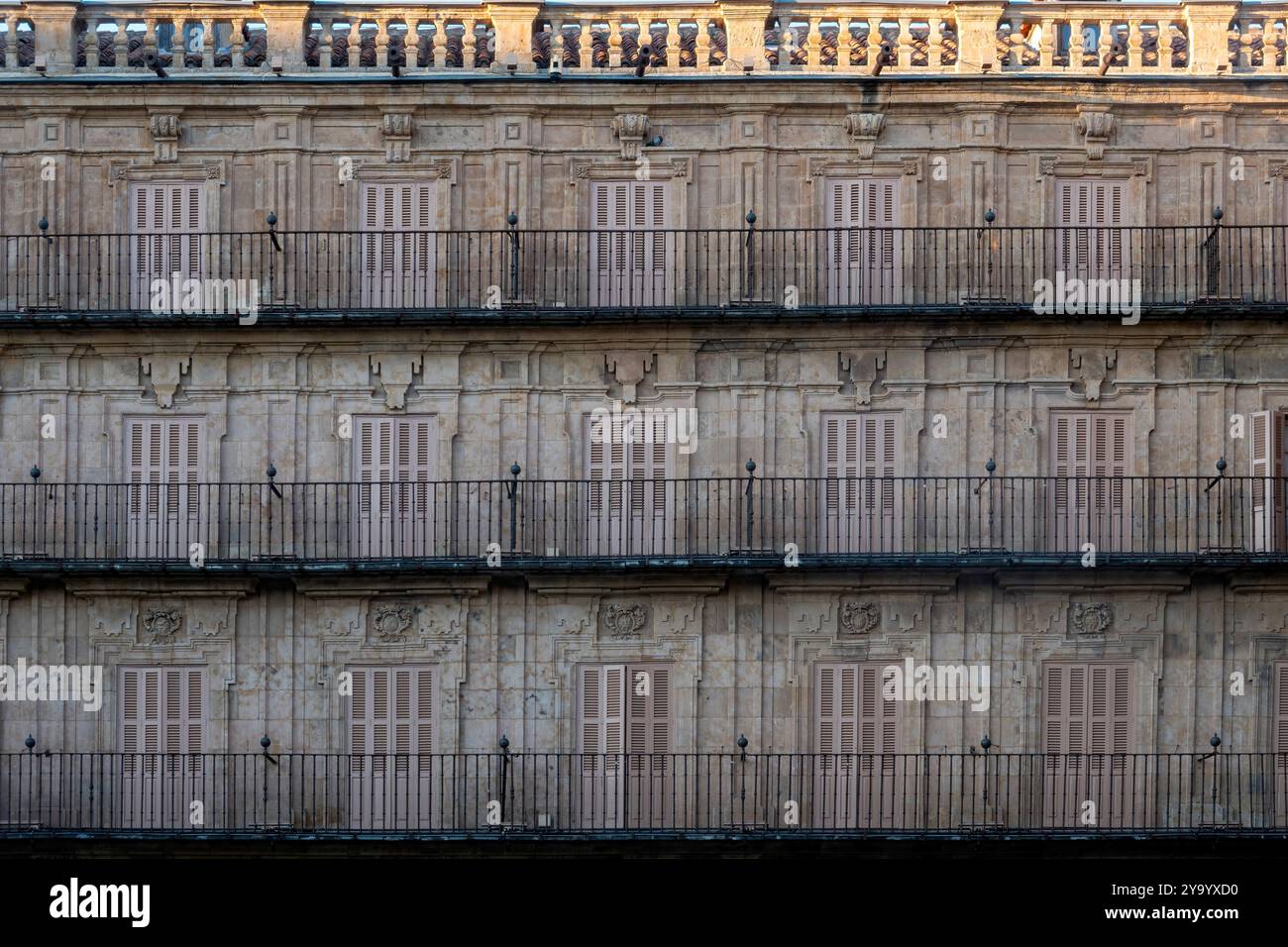 Stone facade of a very old building with closed balconies Stock Photo ...