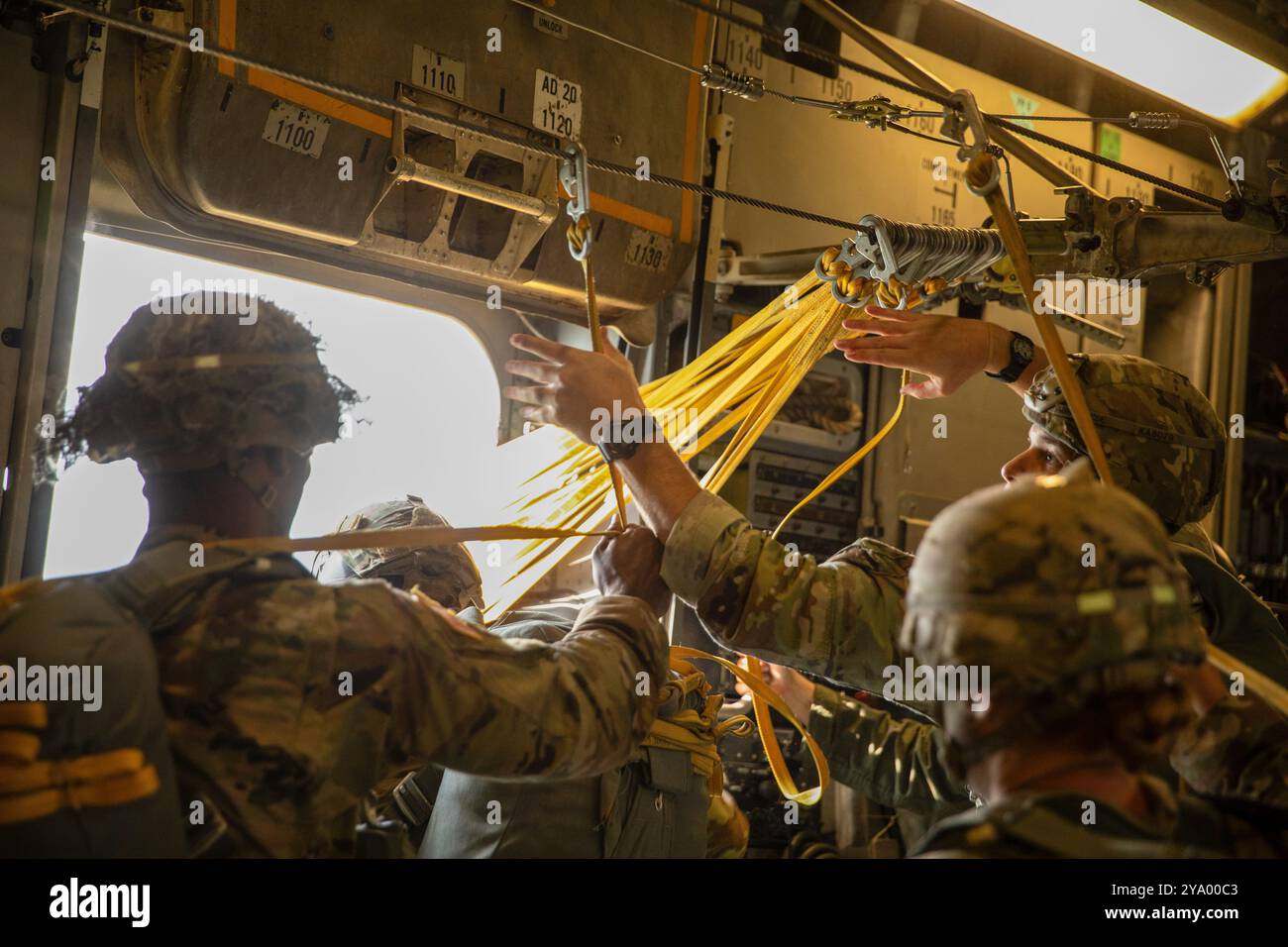 Paratroopers assigned to the 82nd Airborne Division exit a C-17 ...