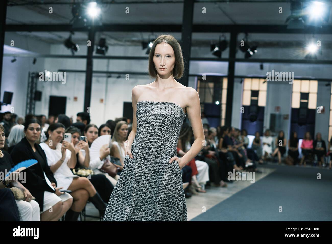 A model walks the runway wearing a design by Roberto Verino during ...