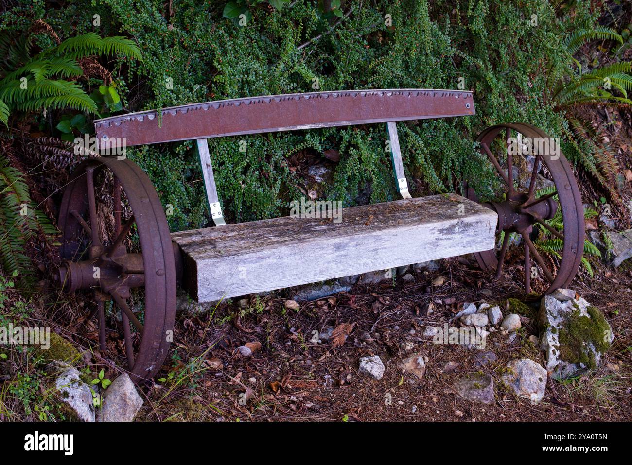 A rustic bench made from an old saw blade and metal wheels on Gambier ...