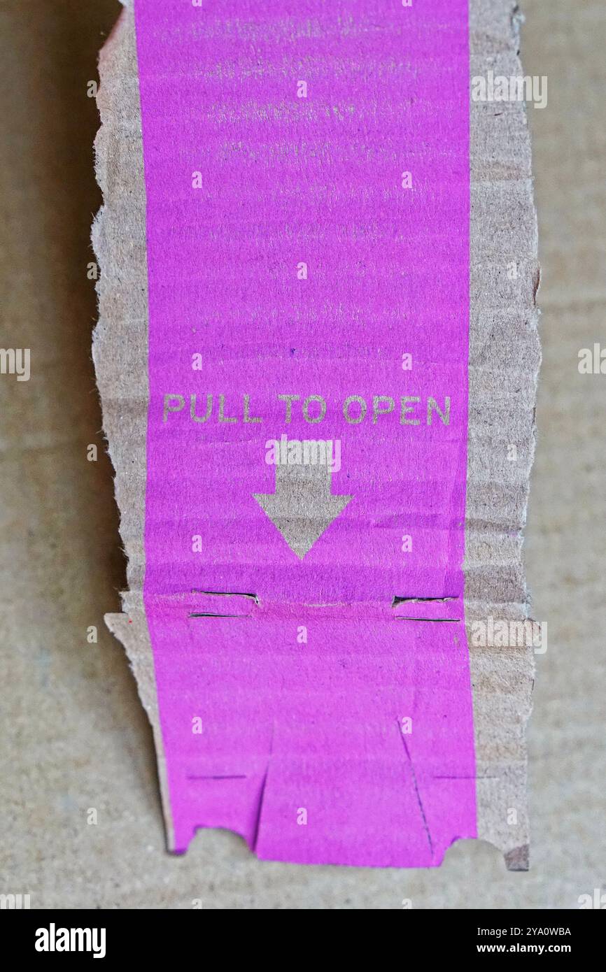 Pull to open pink easy strip at package box parcel Stock Photo - Alamy