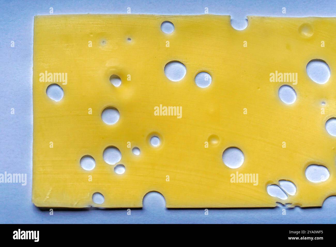One thin slice of emmentaler Swiss cheese with holes Stock Photo - Alamy