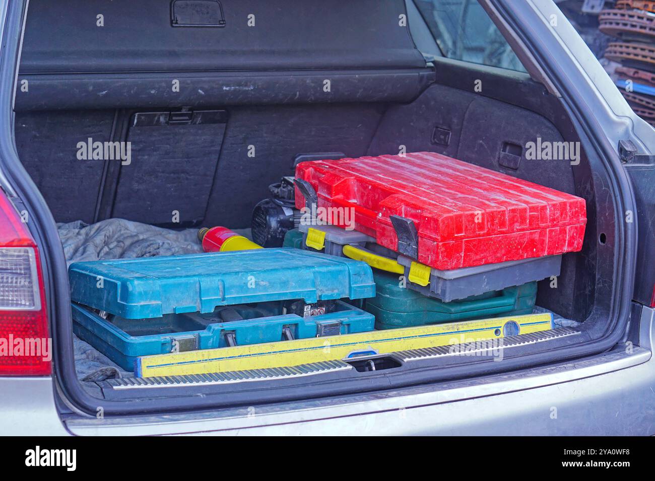 Stack of work tool boxes in open car trunk Stock Photo - Alamy