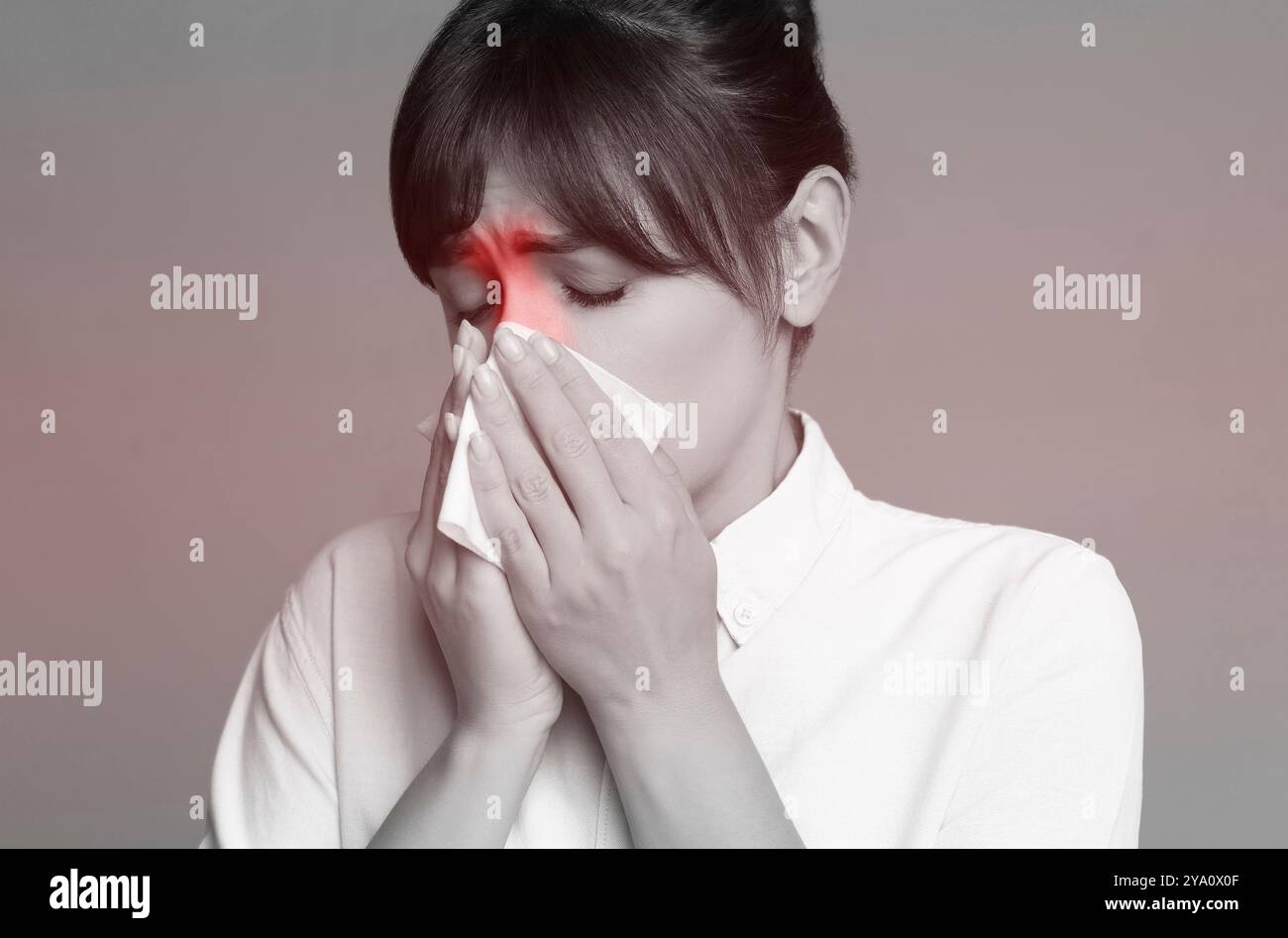 Woman with tissue suffering from sinusitis. Black and white effect with ...