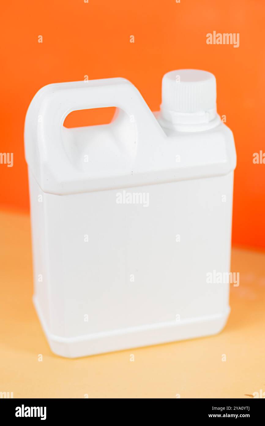 A plain white plastic container with a handle and a screw cap, set ...