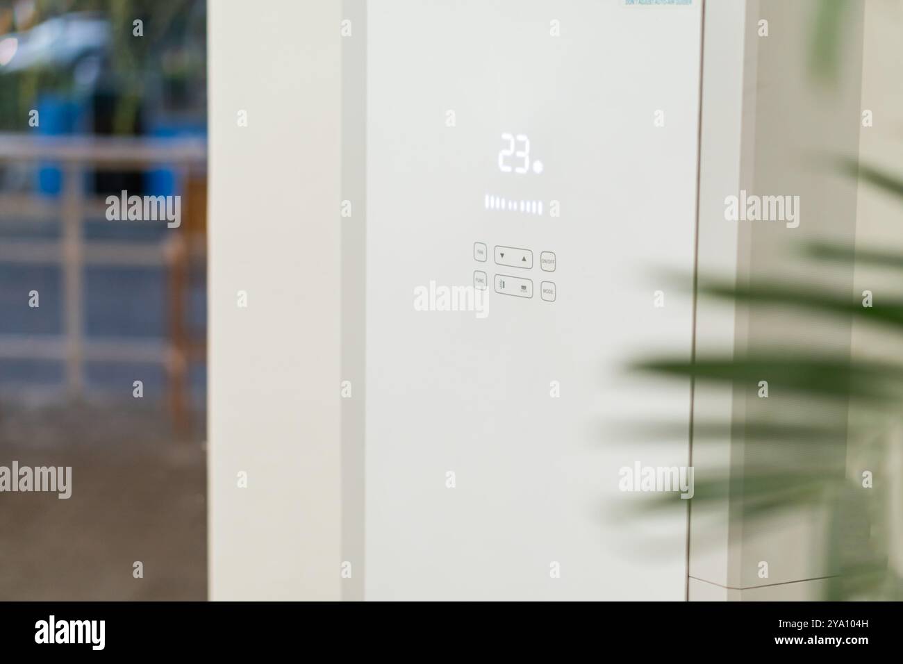 A close-up view of a modern air conditioning unit displaying a digital ...
