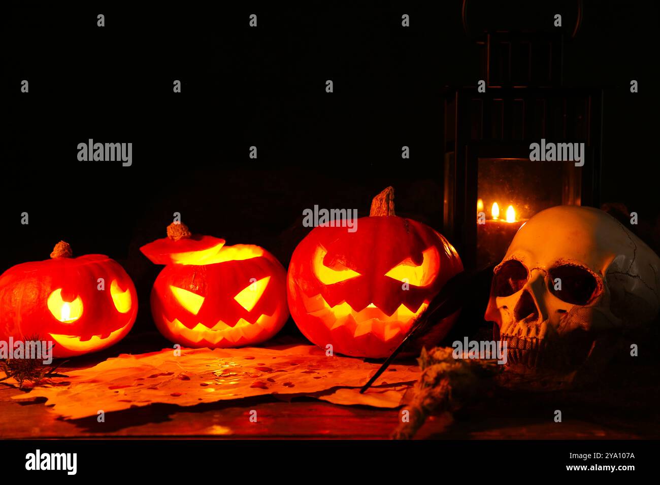 Halloween composition with jack-o-lanterns, skull and scroll on wooden ...