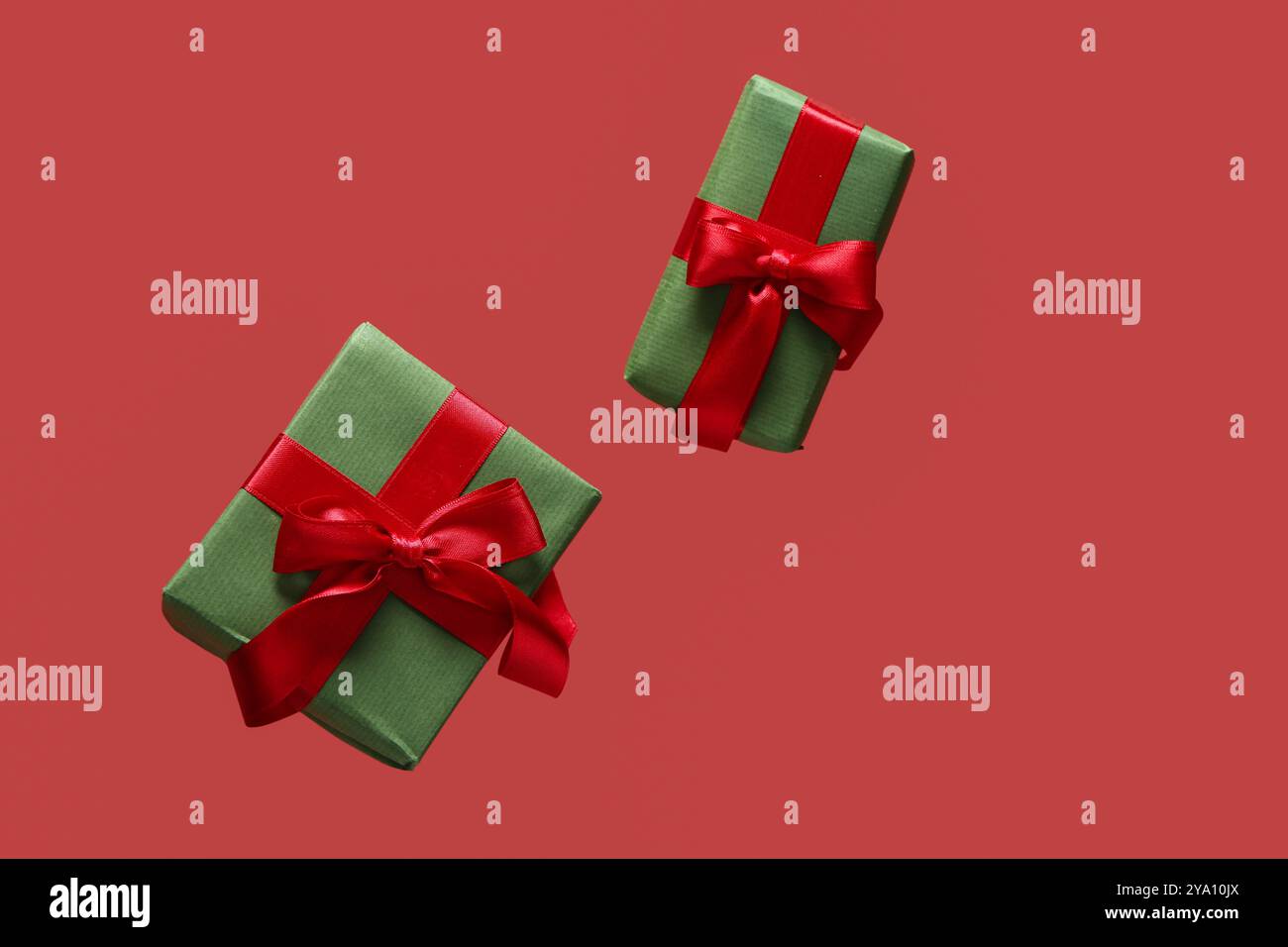 Flying gift boxes on red background Stock Photo - Alamy