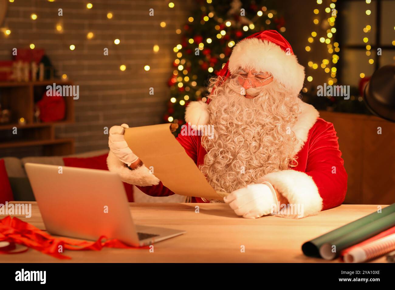 Santa Claus reading letter at home on Christmas eve Stock Photo - Alamy