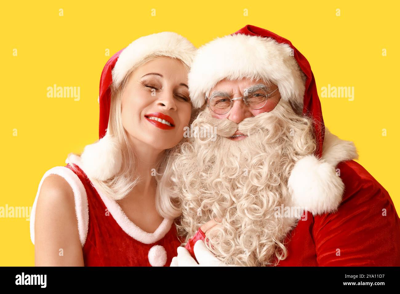 Santa and MRS Claus on yellow background Stock Photo - Alamy