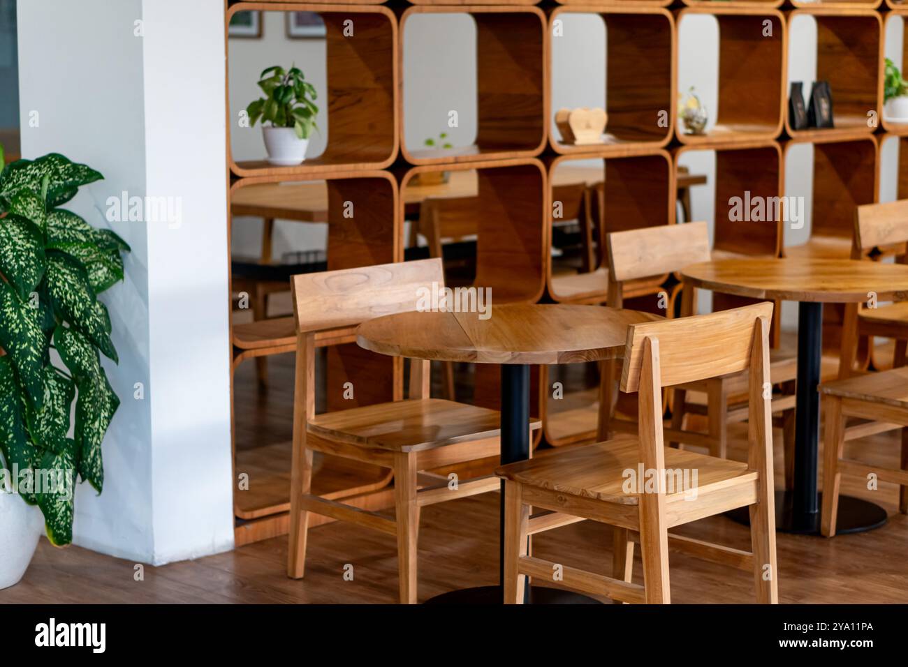 A cozy cafe interior featuring wooden tables and chairs. The design ...