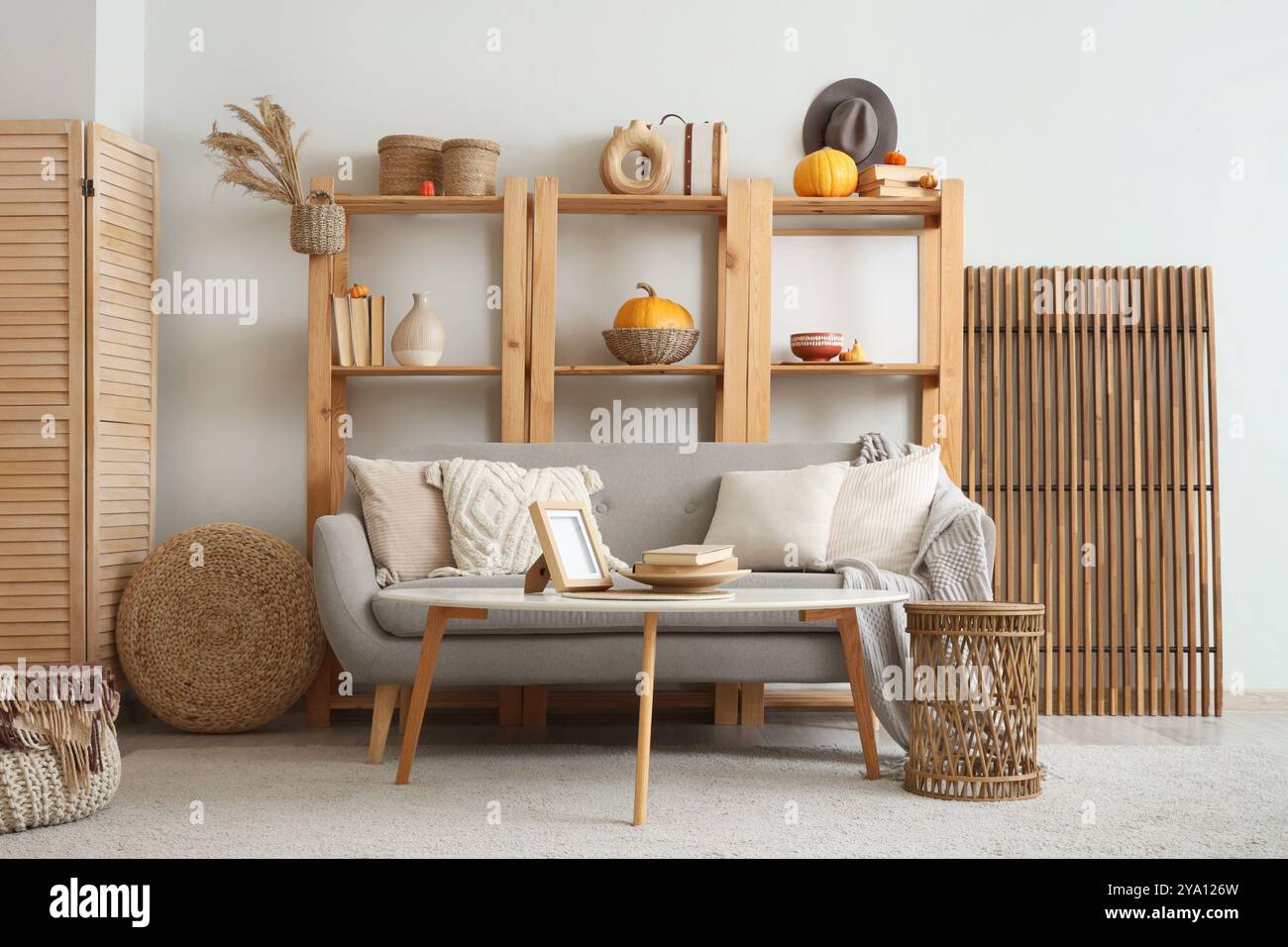 Shelf units, table and sofa in interior of living room Stock Photo - Alamy