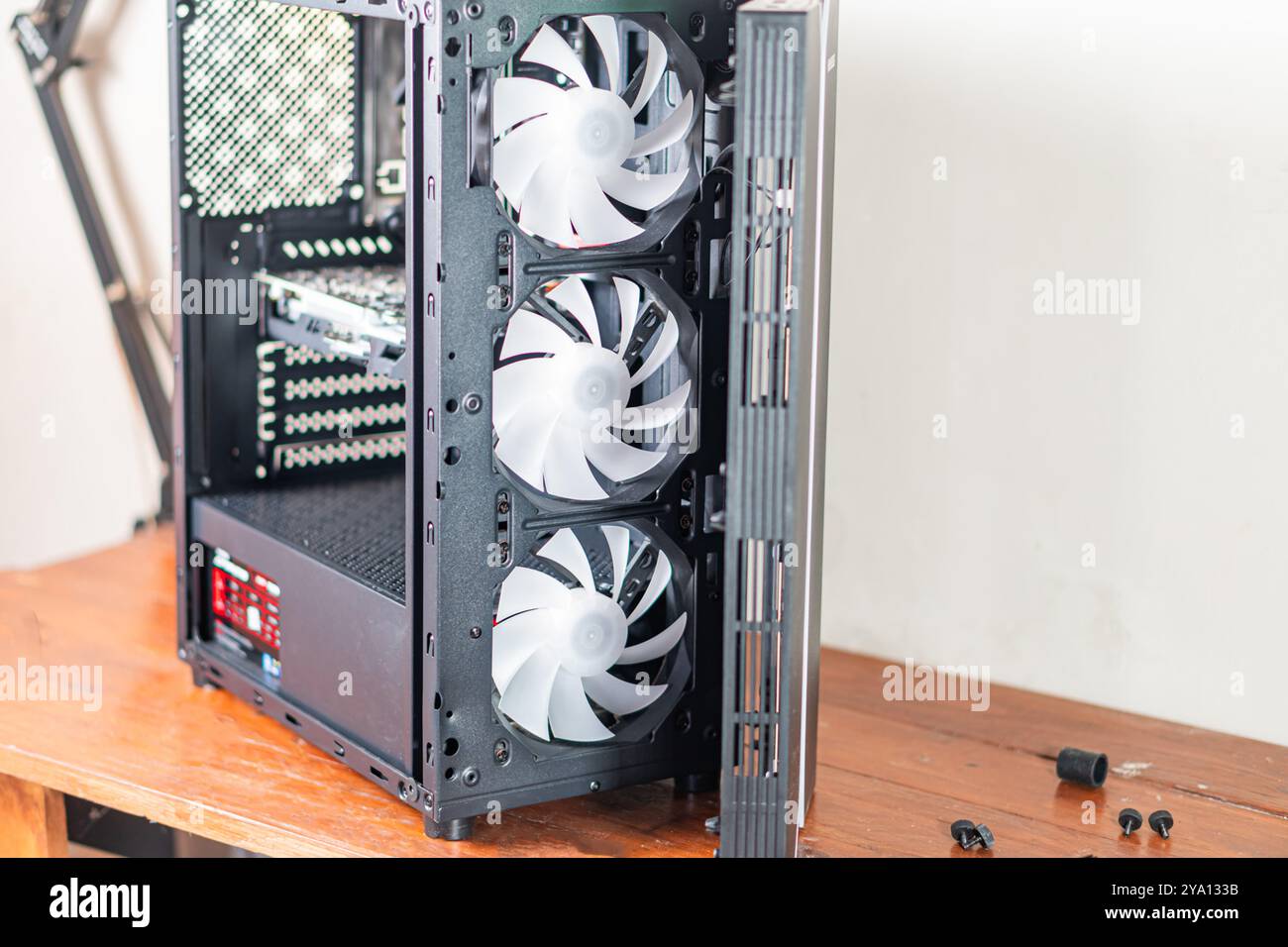 A close-up view of a computer case with three large cooling fans ...