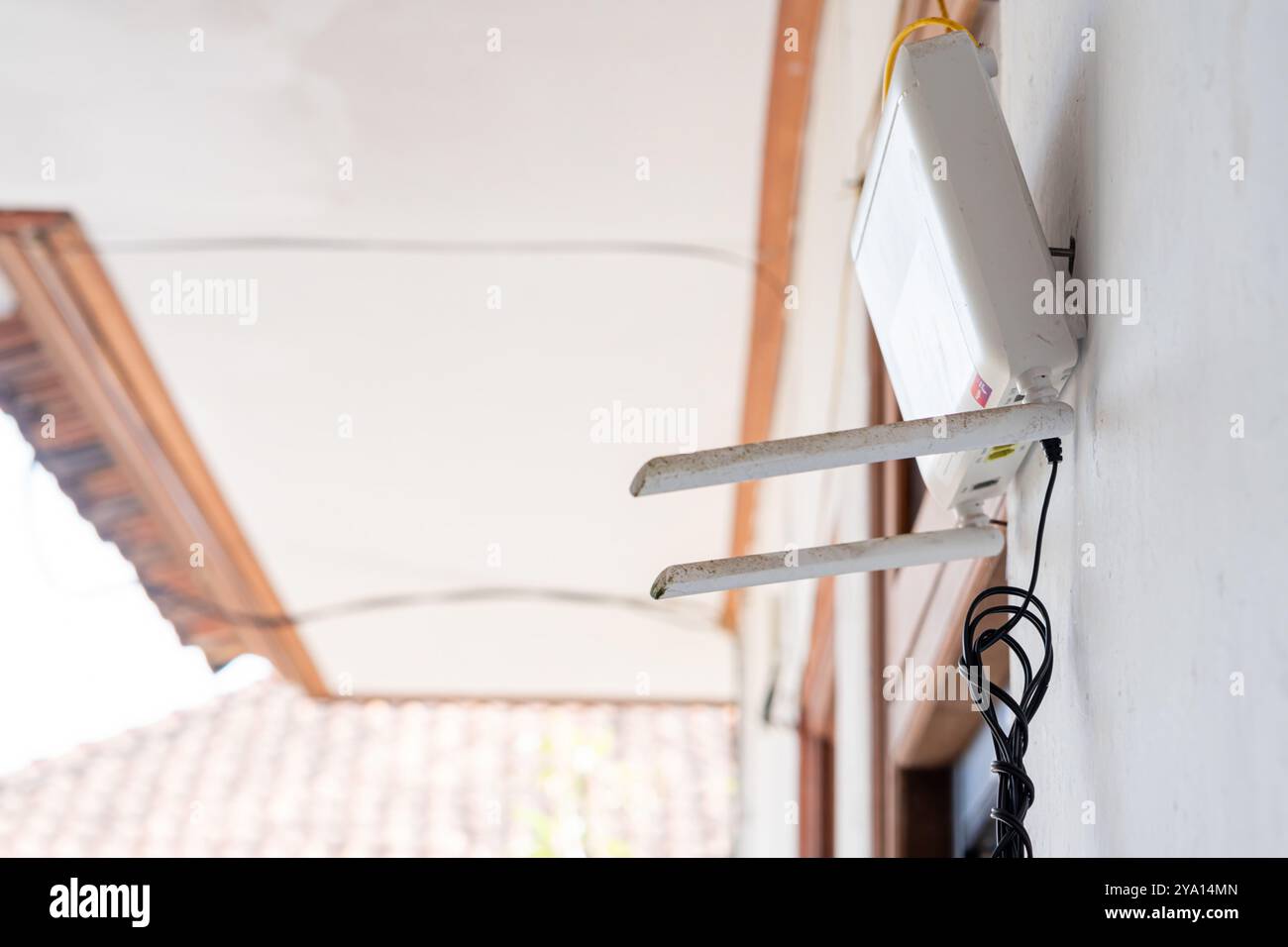 A close-up of a wireless router mounted on a wall, featuring two ...