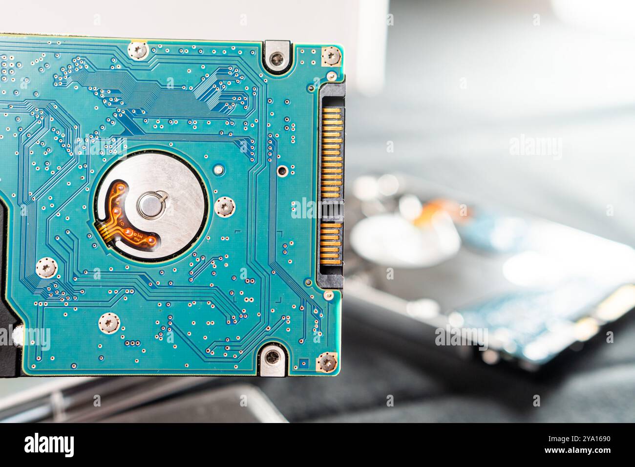 Close-up of a hard disk drive (HDD) showcasing the internal circuit board and components. The ...