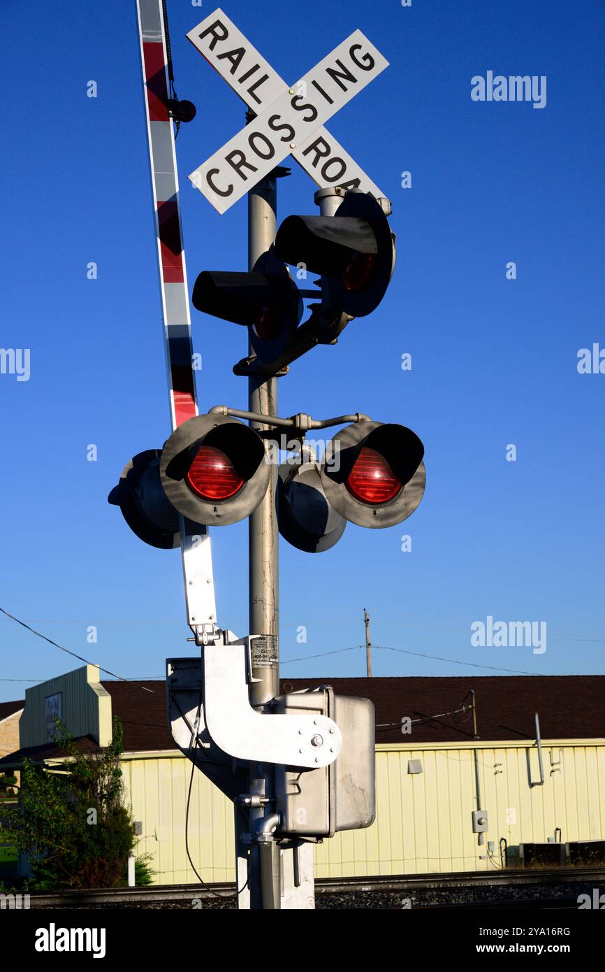Railroad crossing signal on city street Stock Photo - Alamy